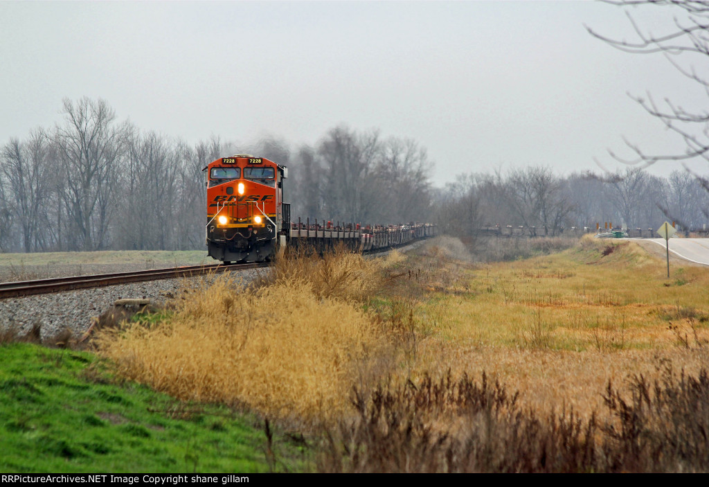 BNSF 7228 Works Nb with a empty bare table train.